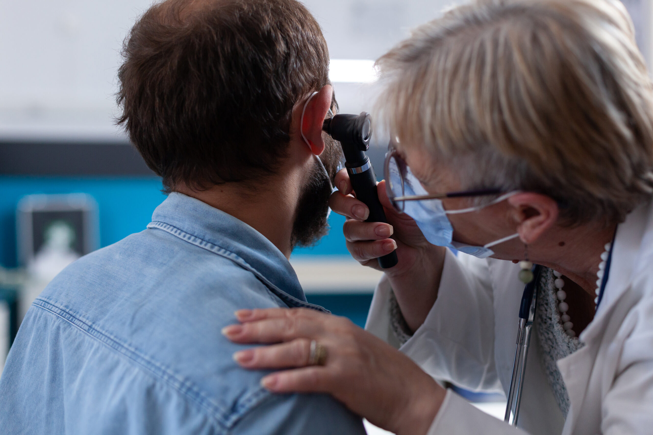 Close up of specialist using otoscope to do ear examination with ...